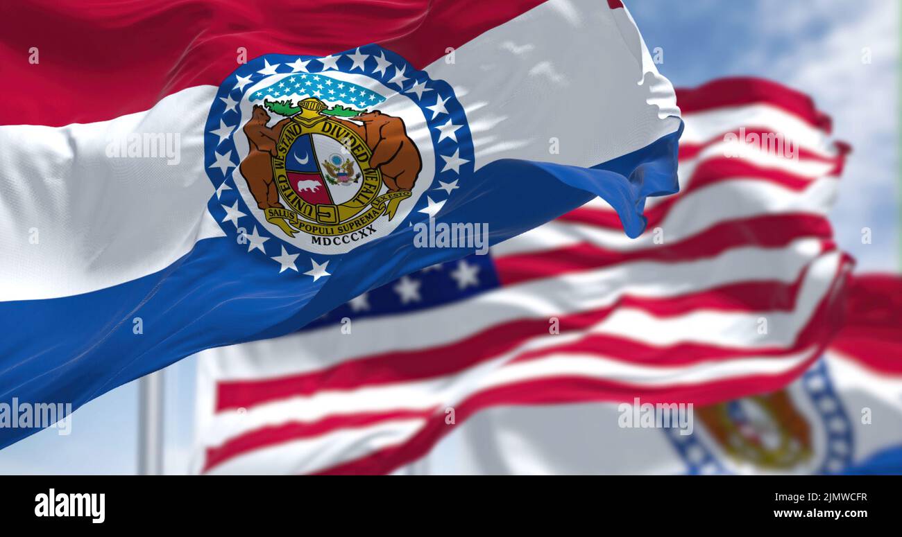 The Missouri state flag waving along with the national flag of the ...
