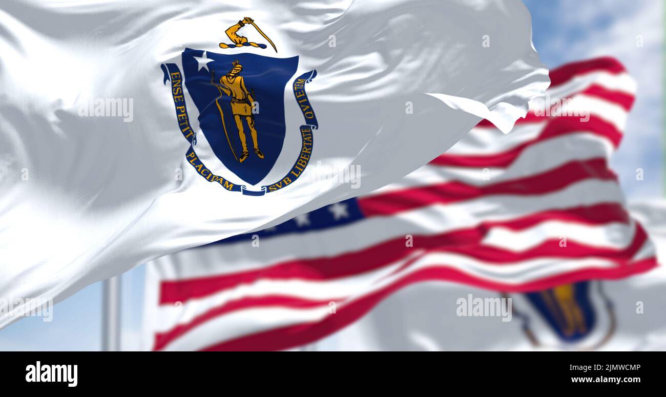 The Massachusetts state flag waving along with the national flag of the ...