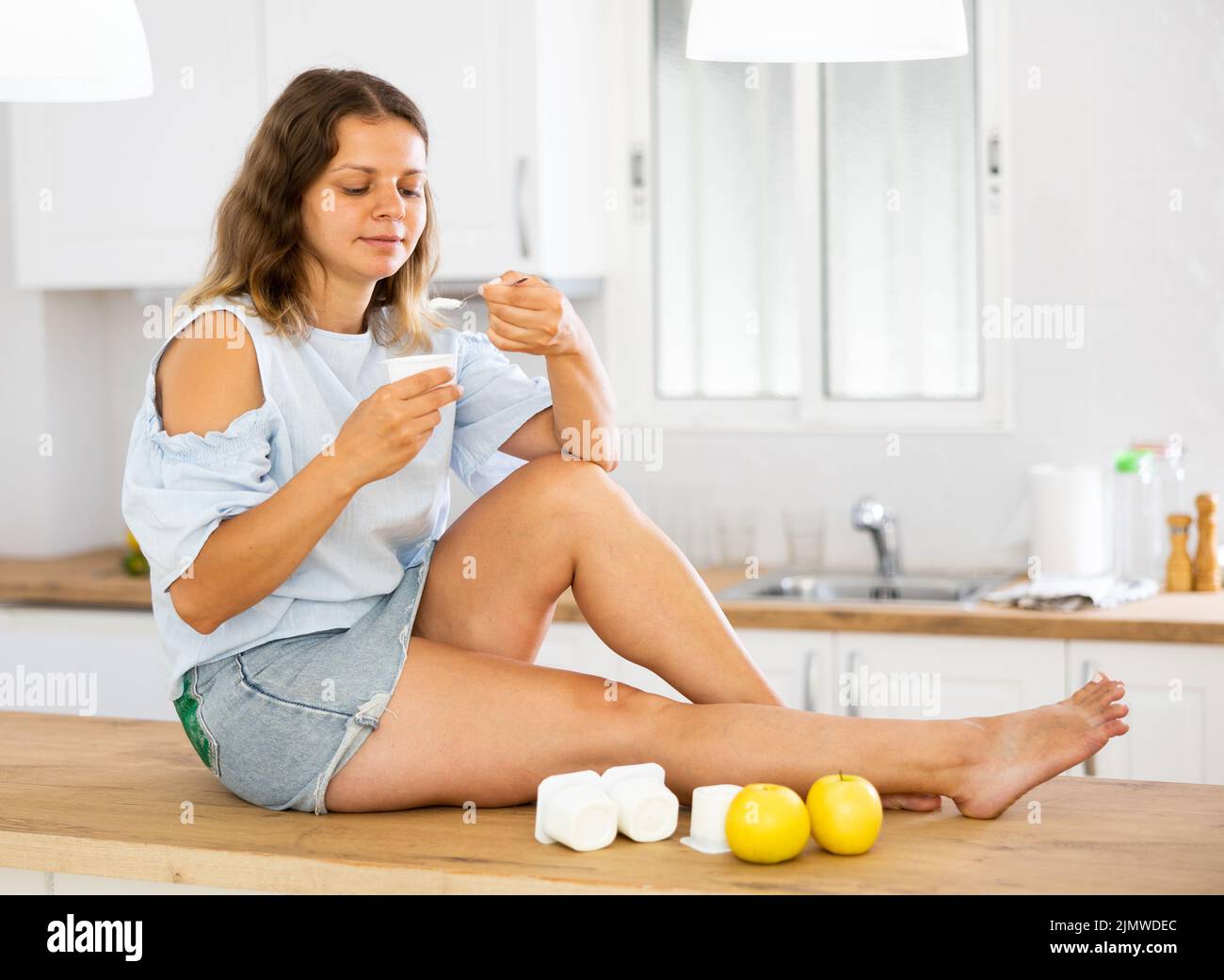 Woman holding portion yogurt hi-res stock photography and images - Alamy