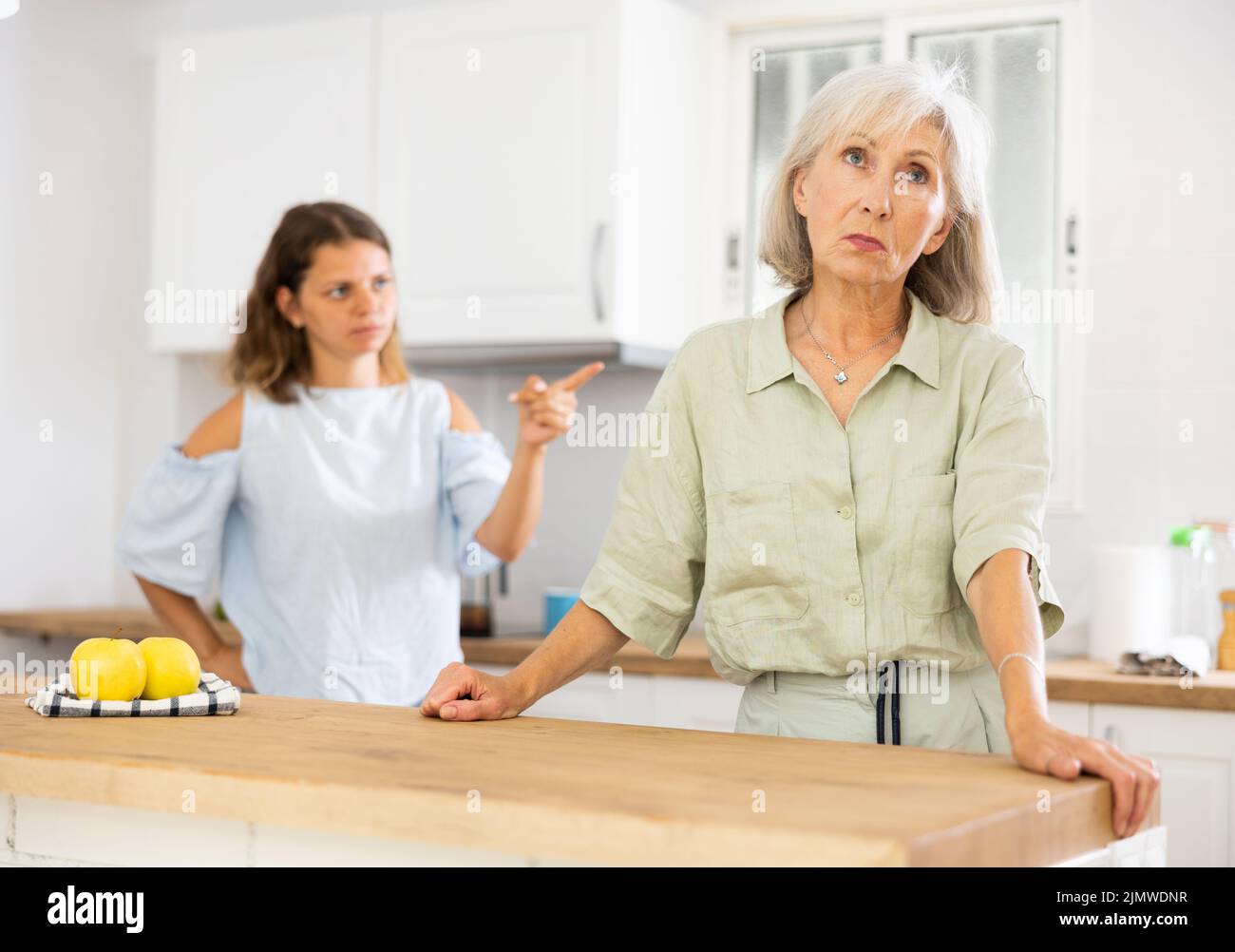 Sad senior woman ignoring her daughter arguing with her Stock Photo - Alamy