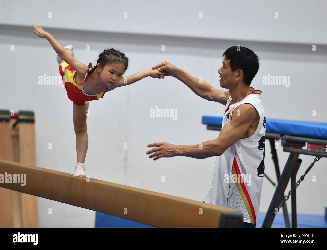 FUYANG, CHINA - AUGUST 7, 2022 - A child practices gymnastics moves ...
