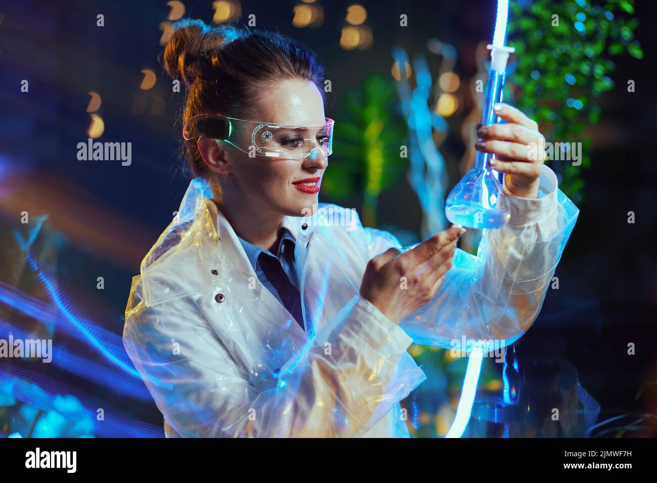 modern scientist woman in lab coat with flask and futuristic goggles in ...