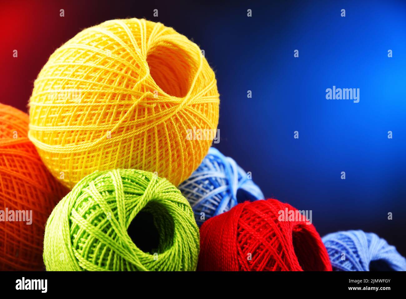 Composition with assortment of different colored yarns and hook for ...