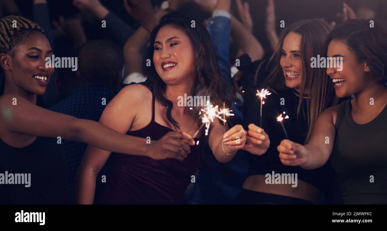 The countdown has begun. a group of girlfriends holding sparklers while ...