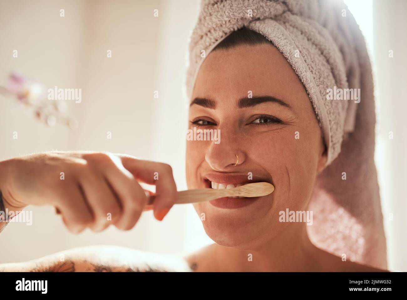 Healthy teeth coming right up. an attractive young woman brushing her ...