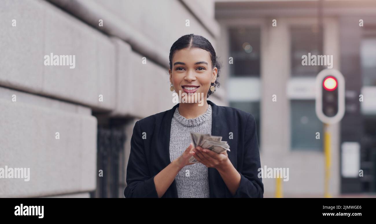Too much money in my hands. an attractive young businesswoman throwing ...