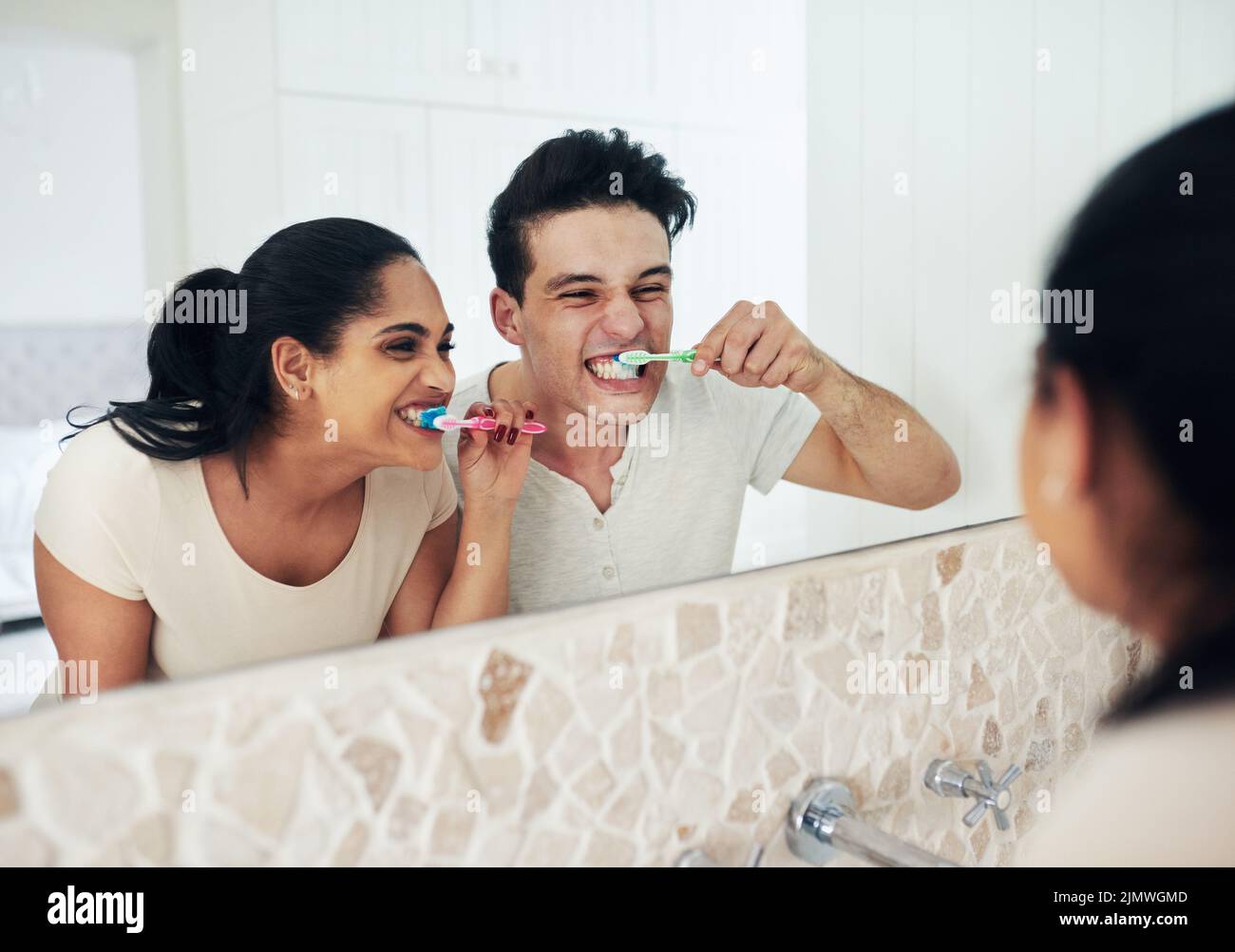 I cant wait for my kiss. a young couple brushing their teeth together ...