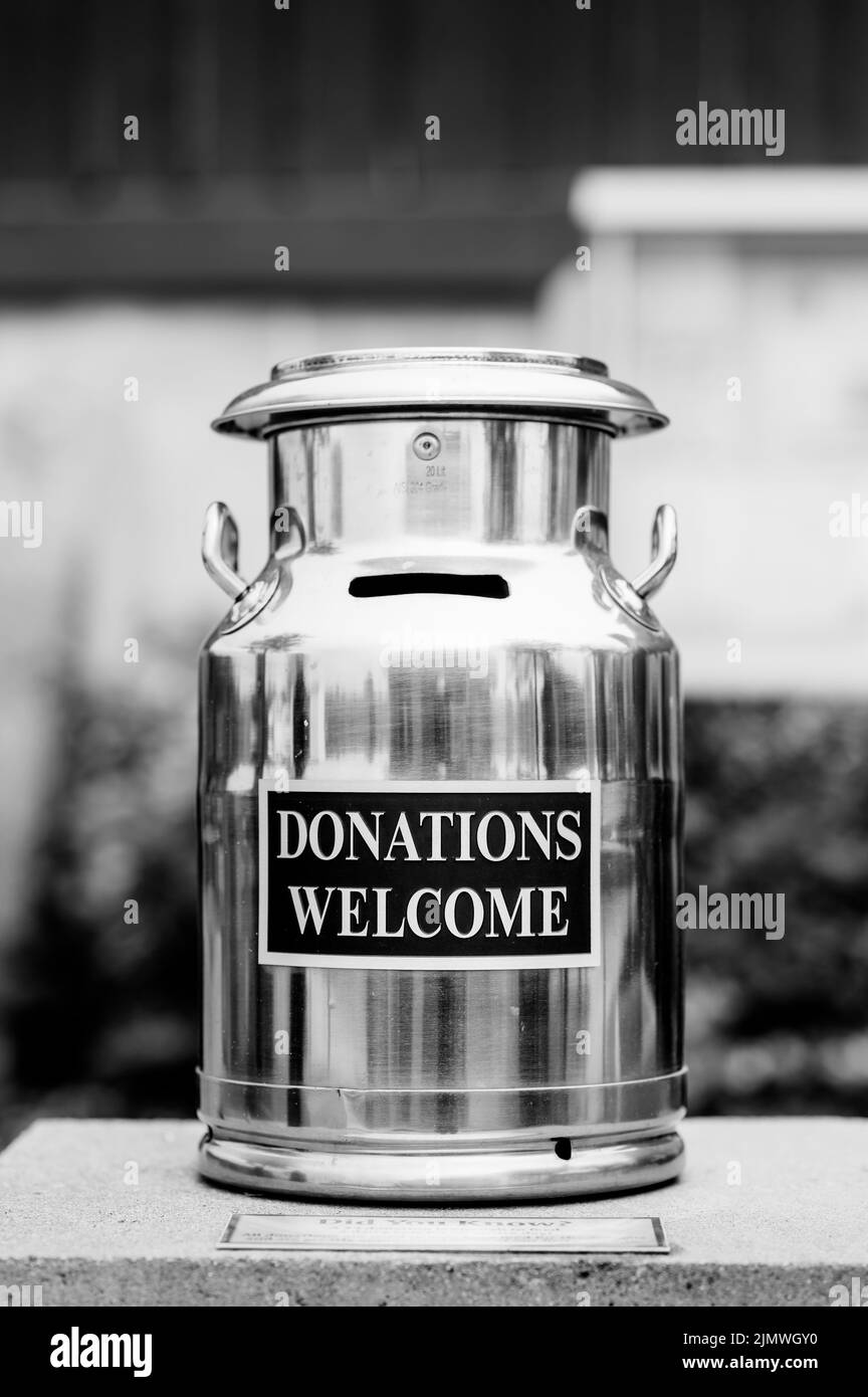 A vertical closeup of a stainless steel donation jar Stock Photo - Alamy