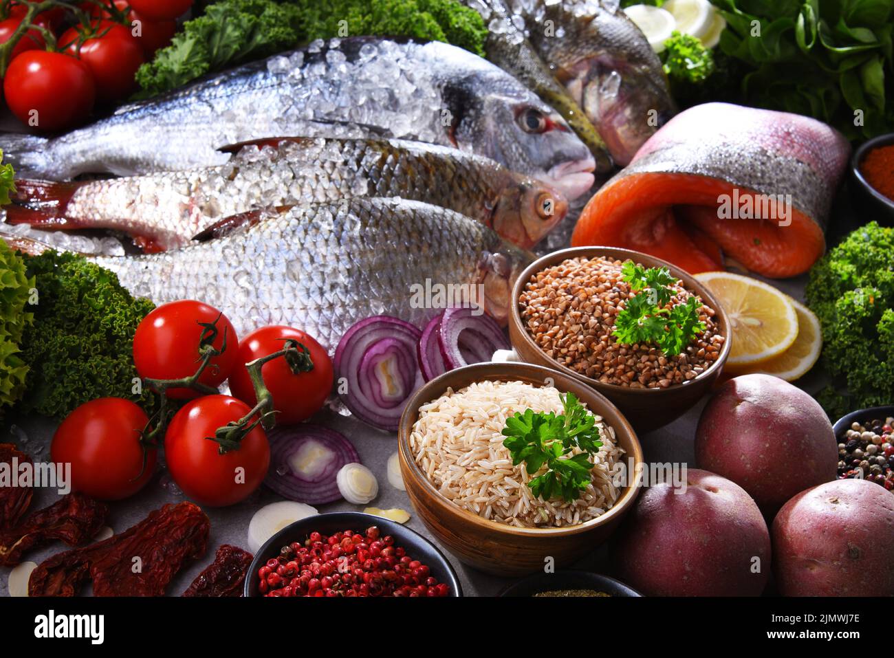 Different sorts of fish on kitchen table Stock Photo - Alamy