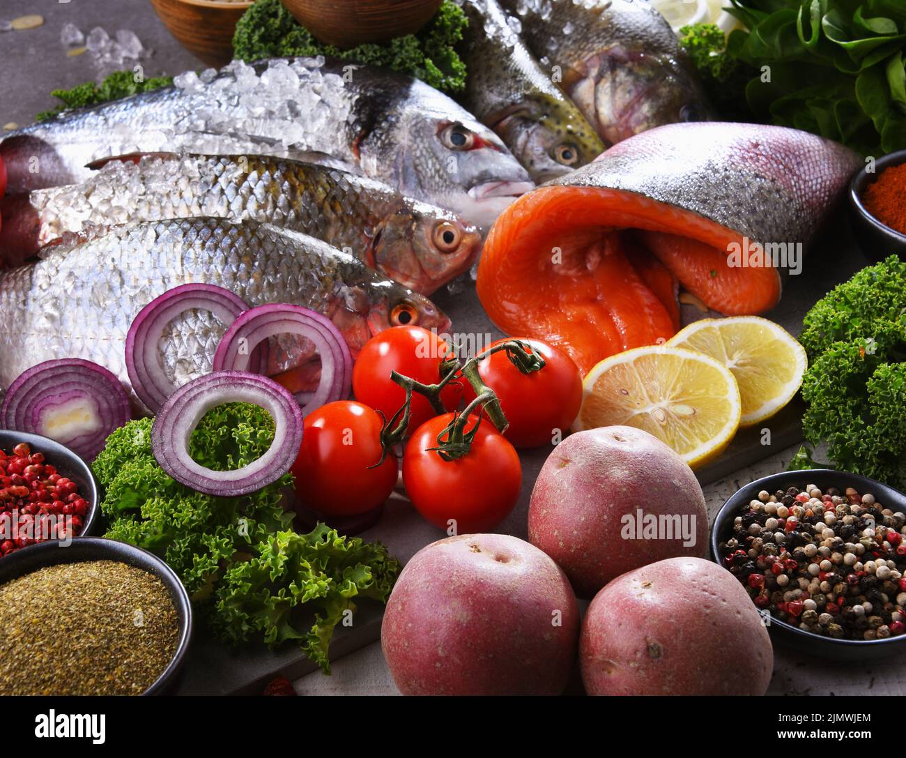 Different sorts of fish on kitchen table Stock Photo - Alamy