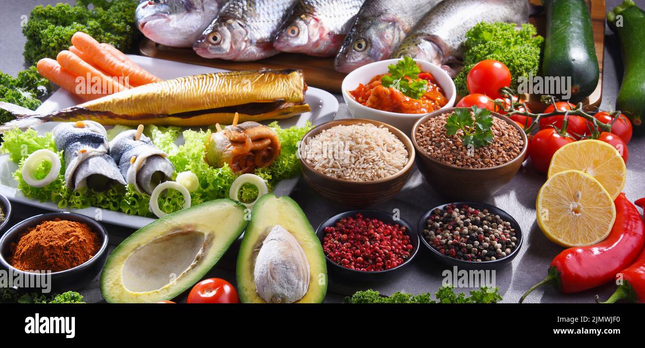 Different sorts of fish on kitchen table Stock Photo - Alamy