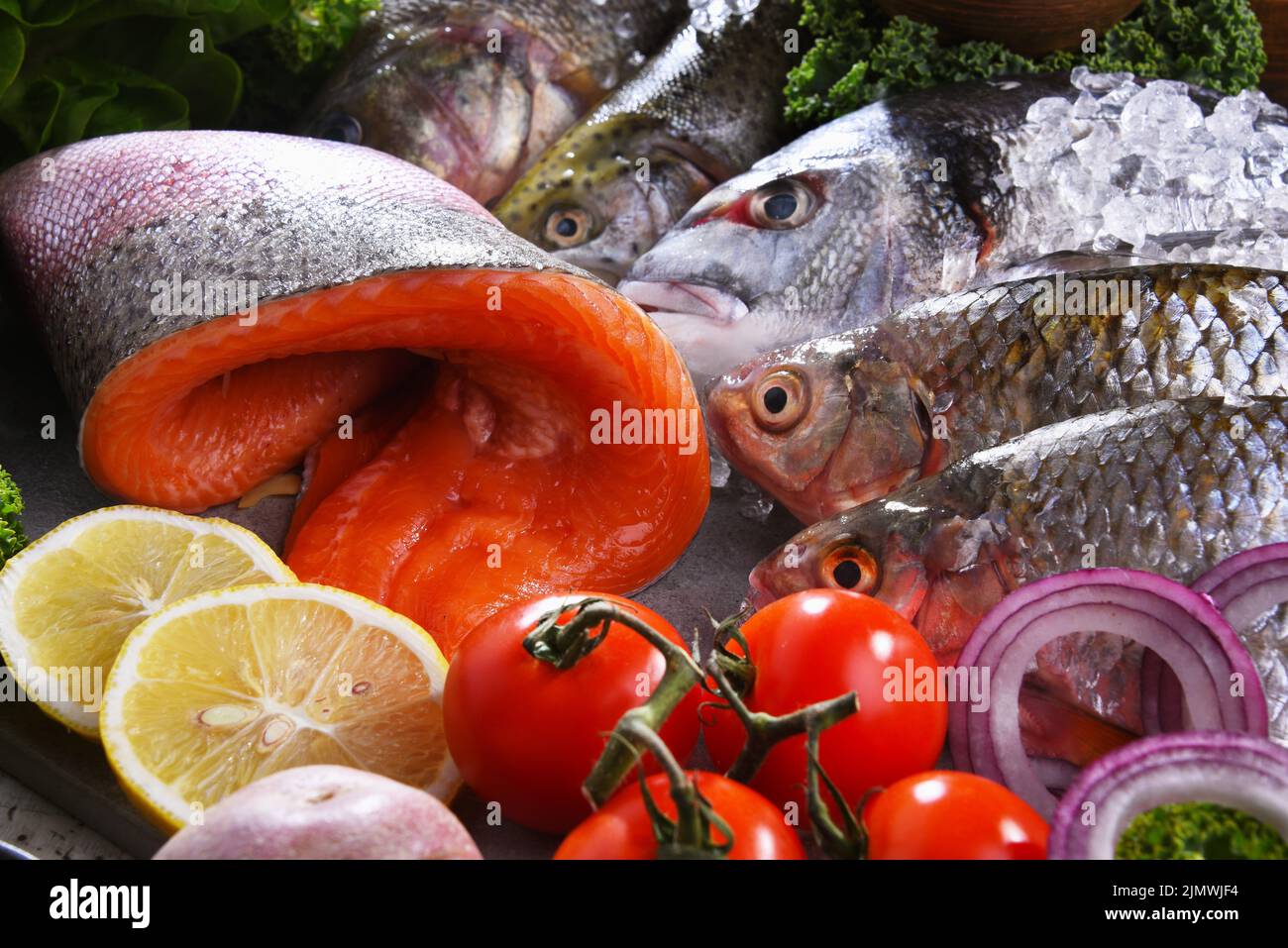 Different sorts of fish on kitchen table Stock Photo - Alamy