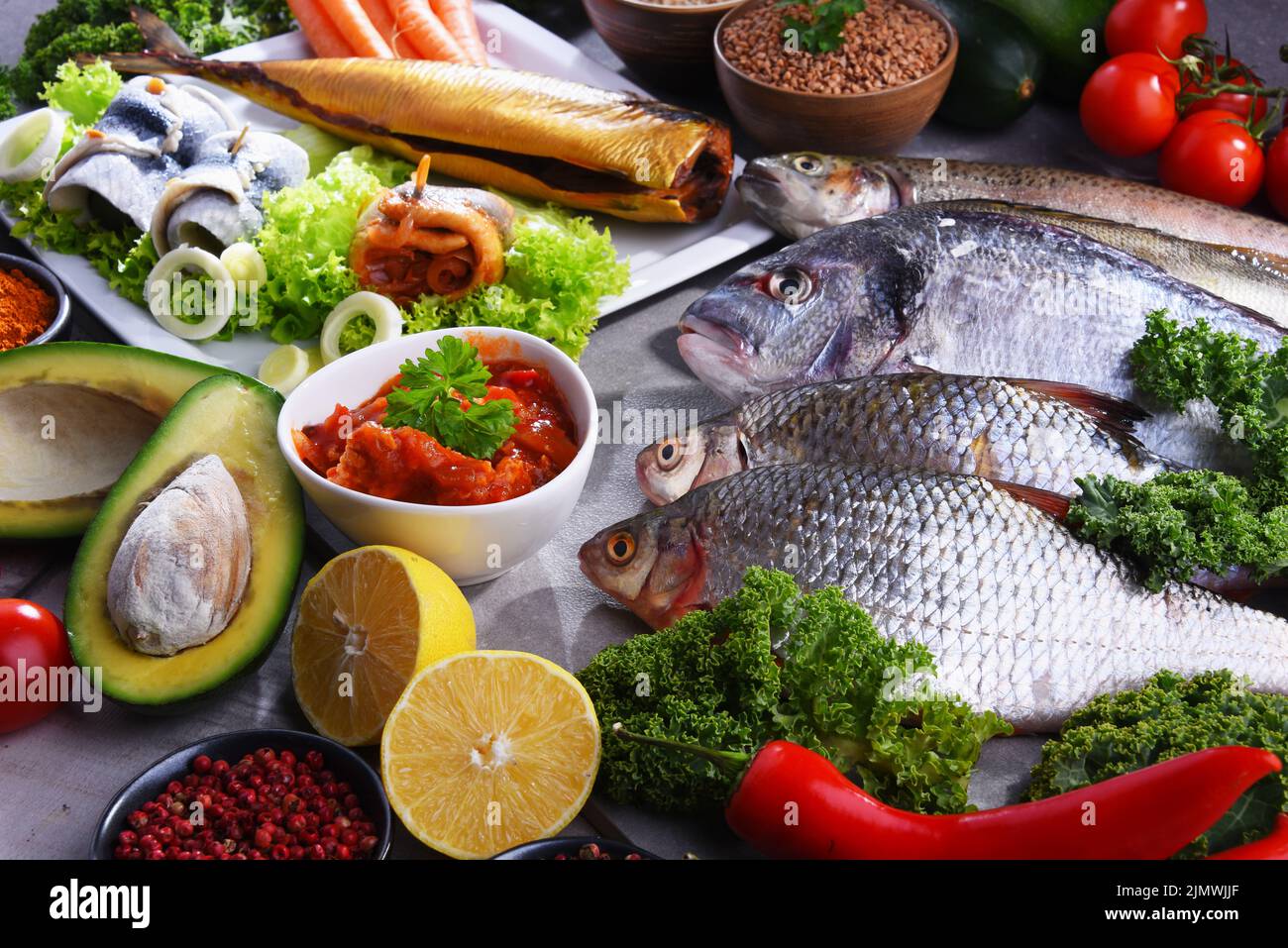 Different sorts of fish on kitchen table Stock Photo - Alamy