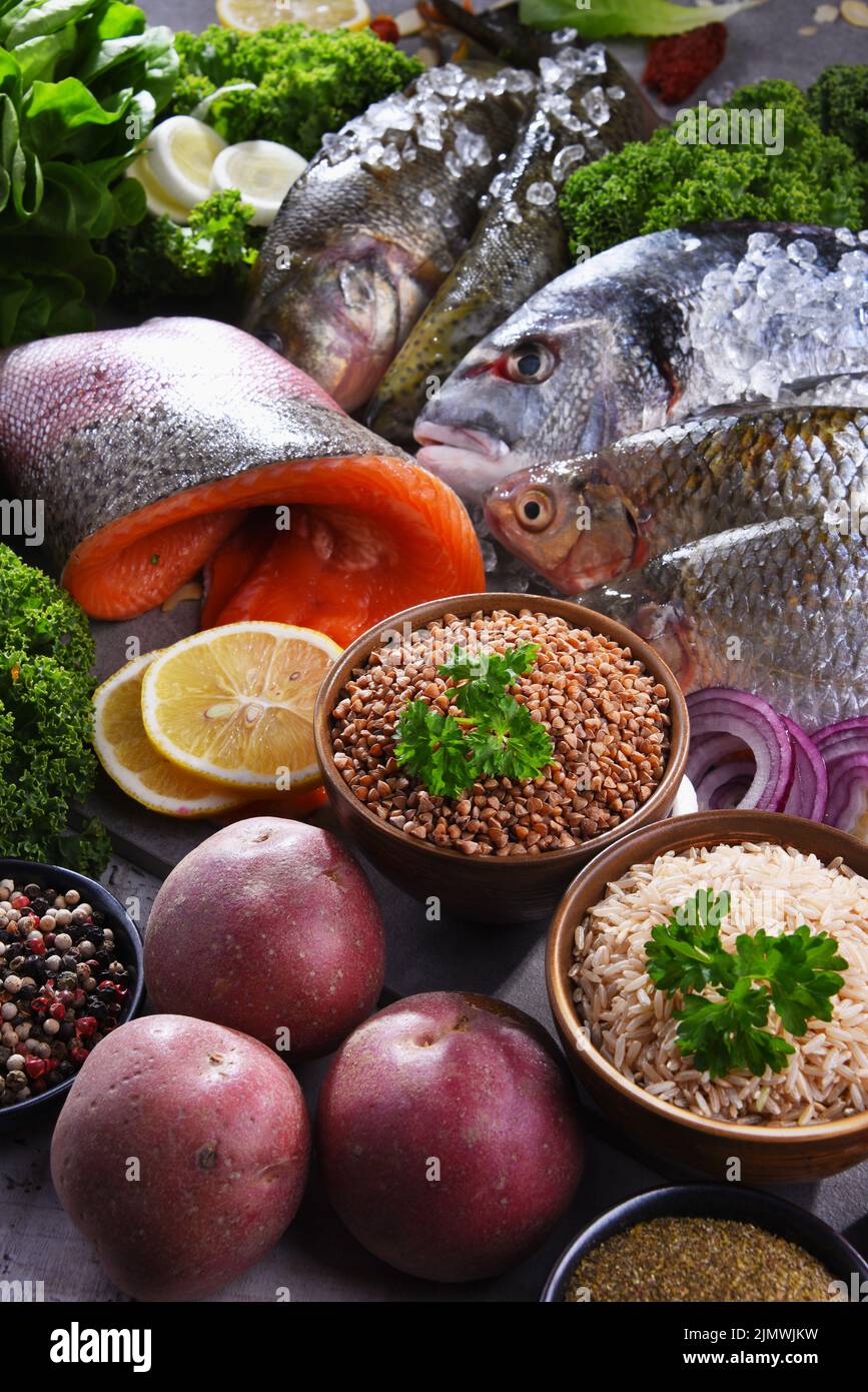 Different sorts of fish on kitchen table Stock Photo - Alamy