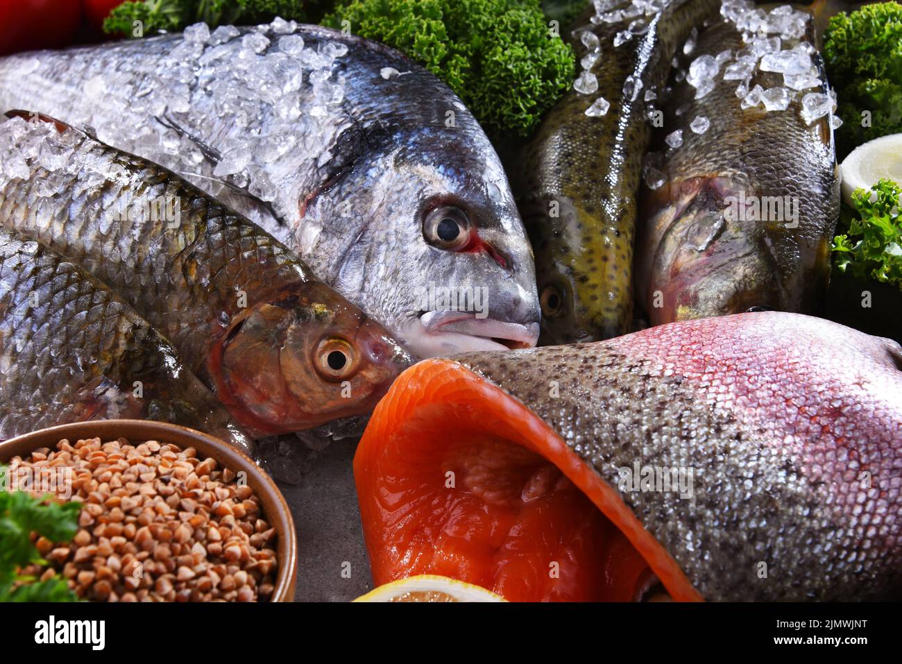 Different sorts of fish on kitchen table Stock Photo - Alamy