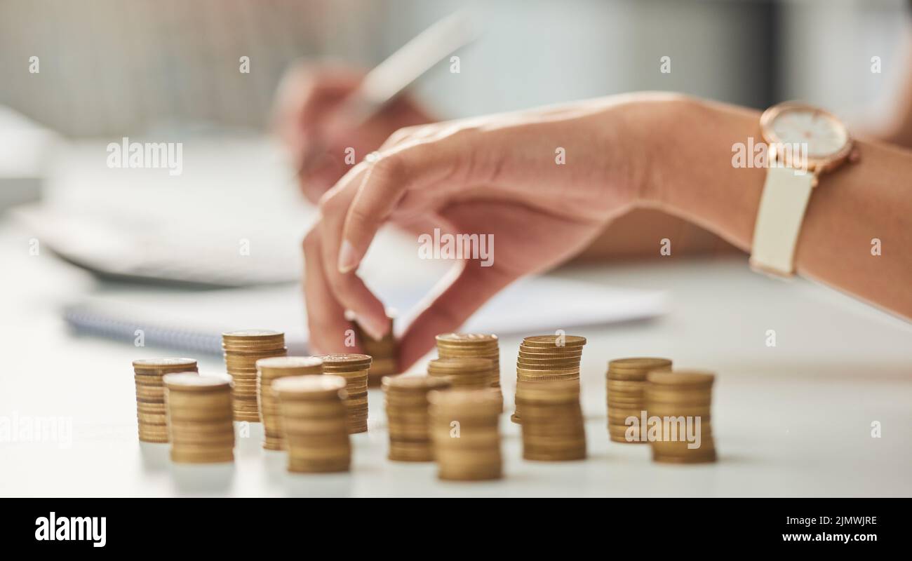 Counting those pennies. an unrecognizable businesswoman stacking coins ...