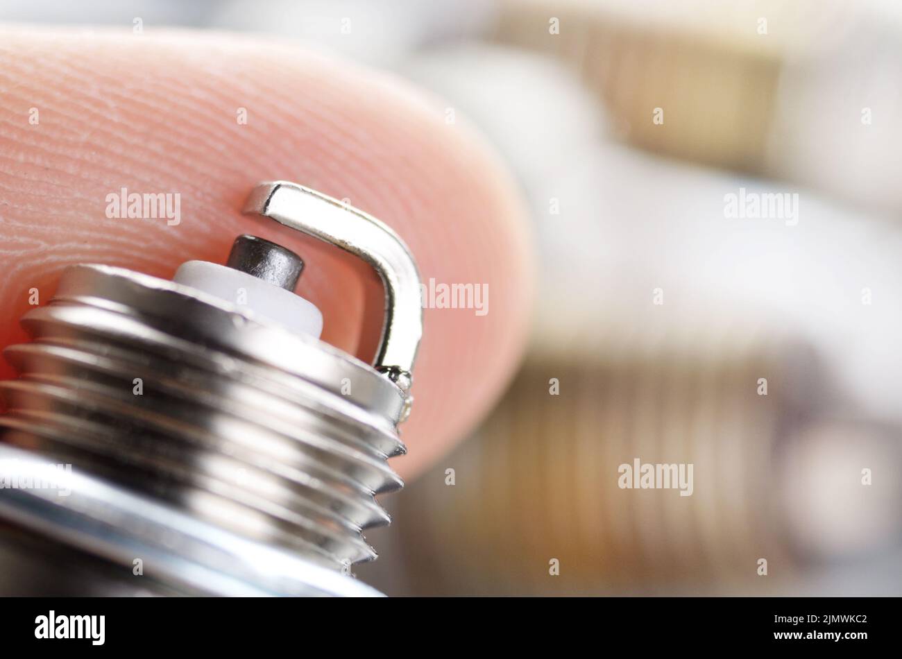 Closeup photo of new spark plug for internal combustion engine in human ...