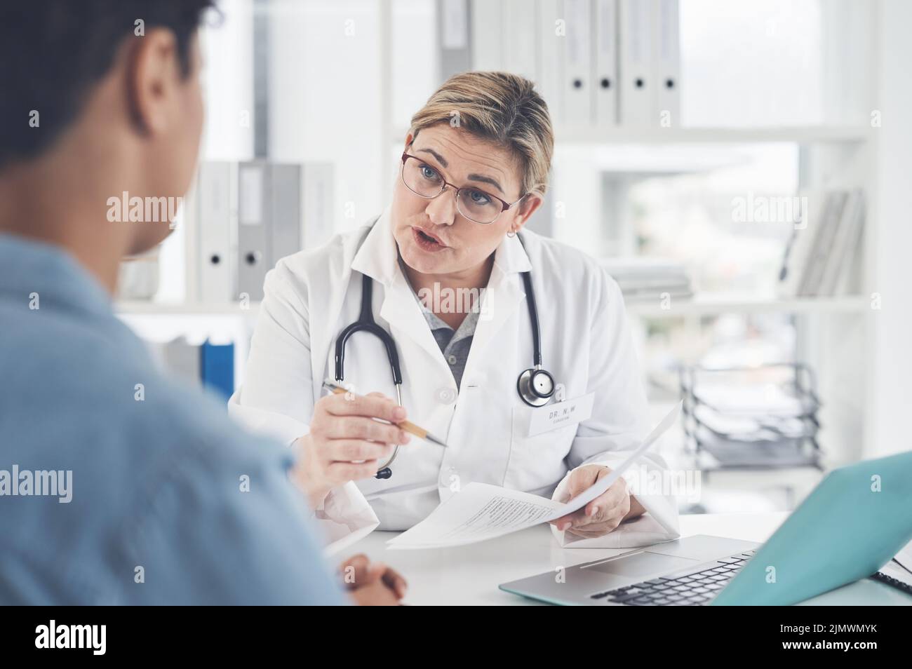 Attractive young doctor having discussion hi-res stock photography and ...