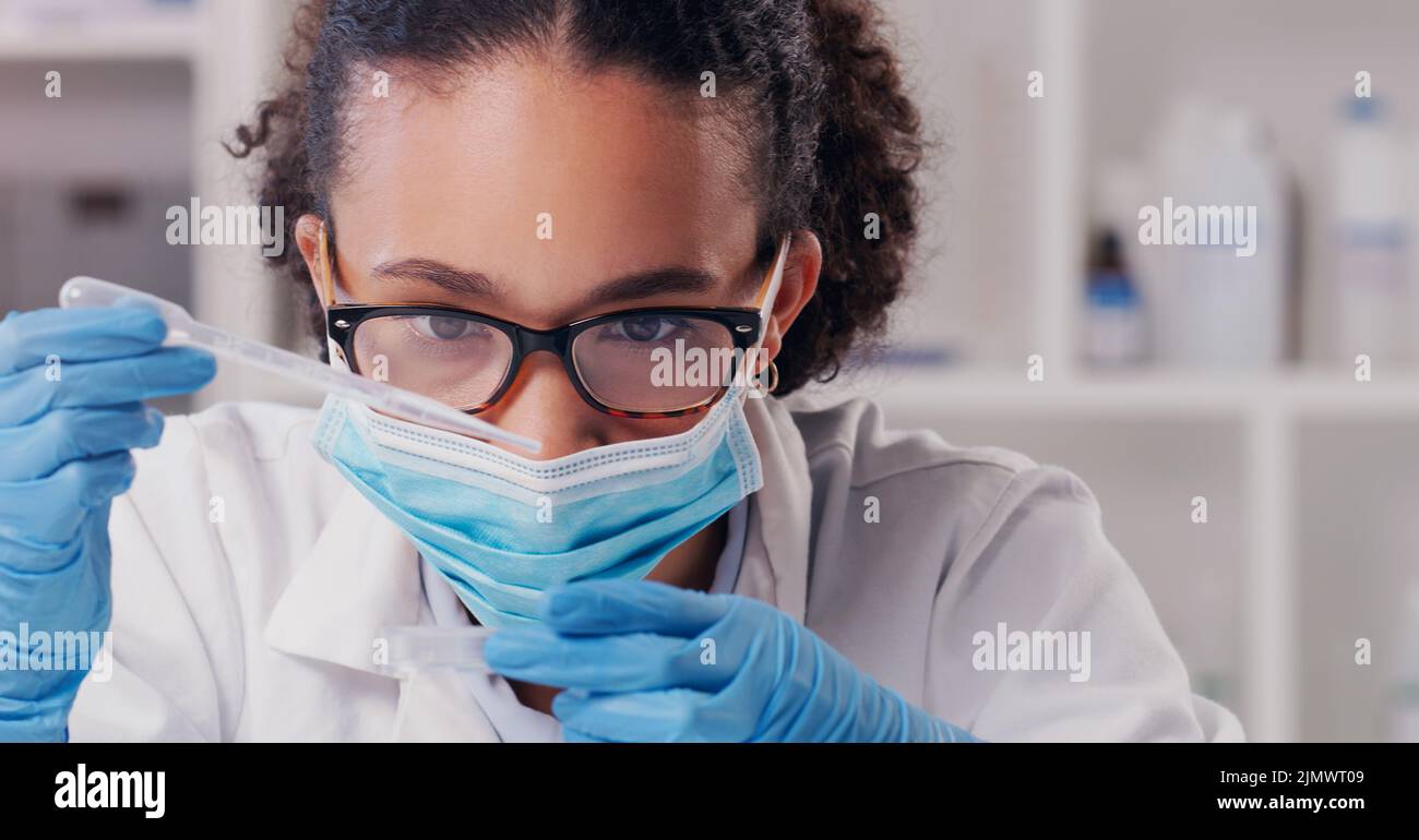 Starting a new experiment. a young scientist analysing samples in a lab ...
