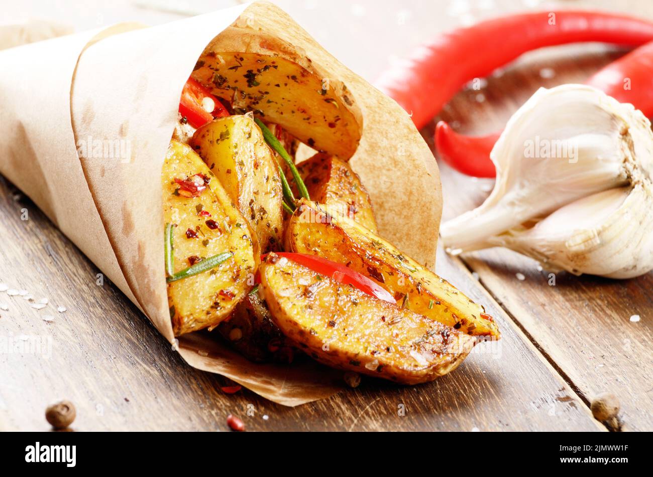 Boiled and baked potato in paper Stock Photo - Alamy