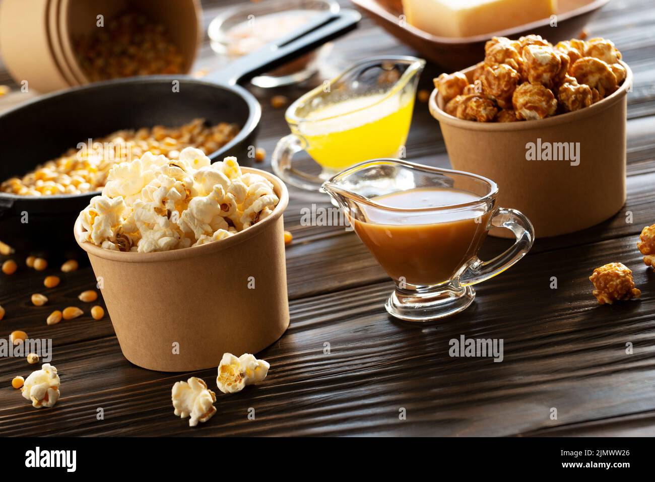 Paper buckets with butter and caramel popcorn on kitchen table Stock ...