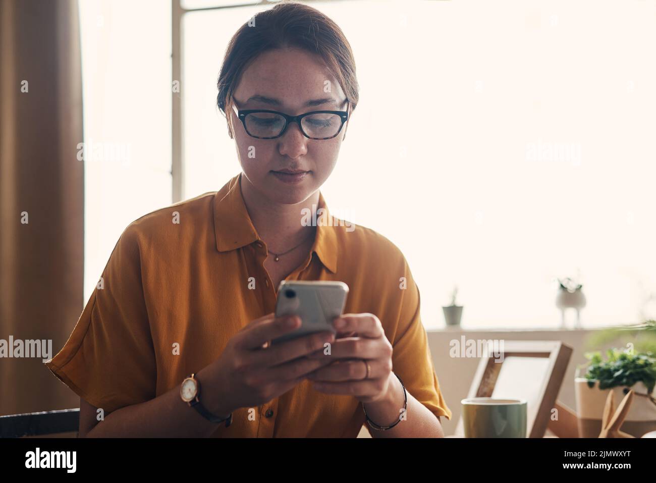 Focus and discipline gets it done. a young woman using a smartphone ...