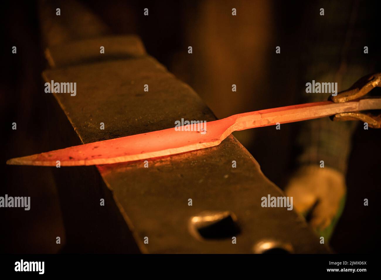 Forging a knife out of the hot metal Stock Photo - Alamy