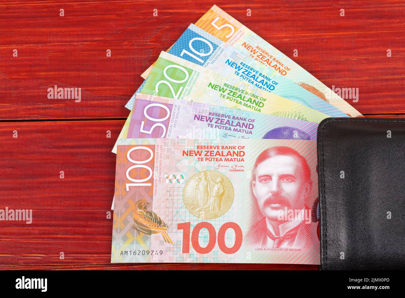 Money from New Zealand in the black wallet Stock Photo - Alamy