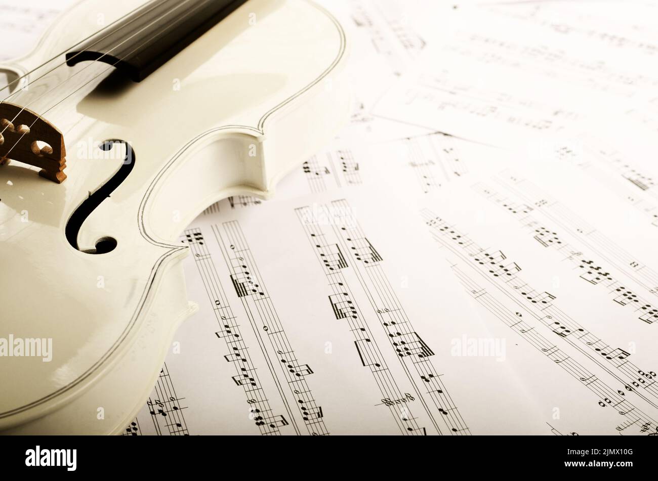Close view of a violin and musical notes on white wooden table Stock ...