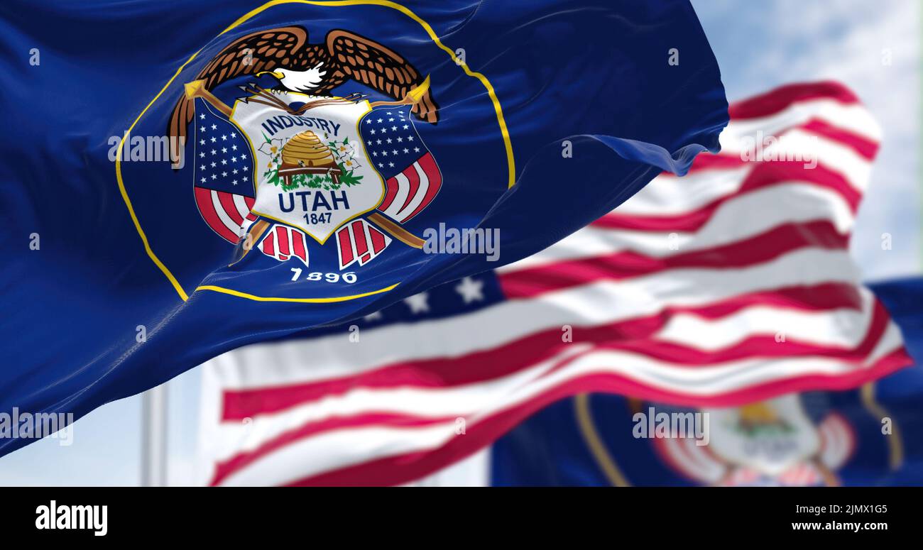 The Utah state flag waving along with the national flag of the United ...