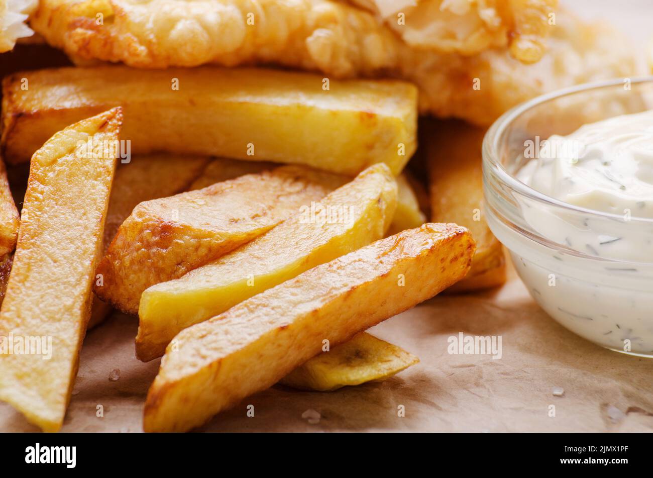 Traditional British street food fish and chips with tartar sauce on ...