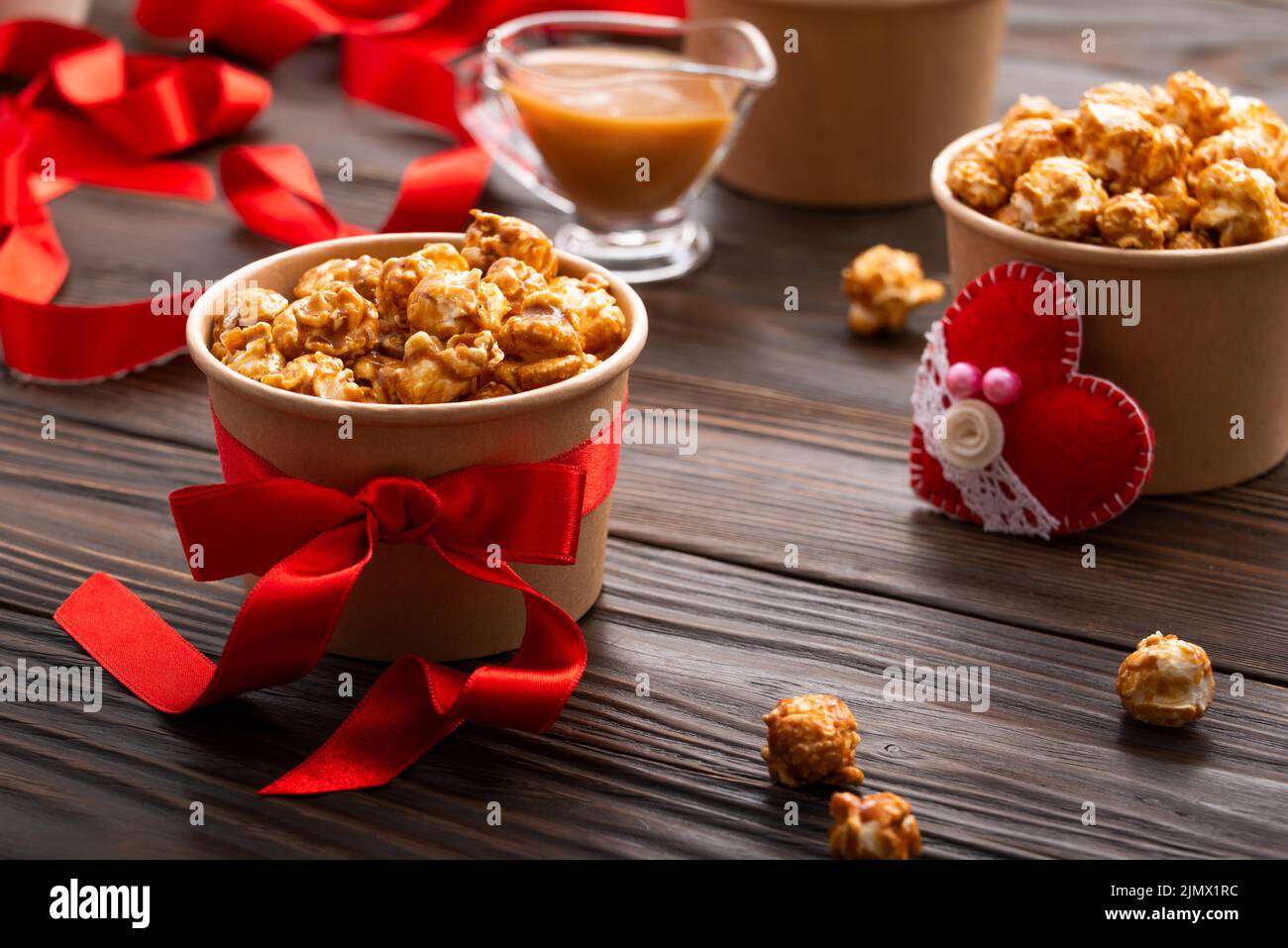 Carton buckets with caramelized popcorn and valentine decorations on ...