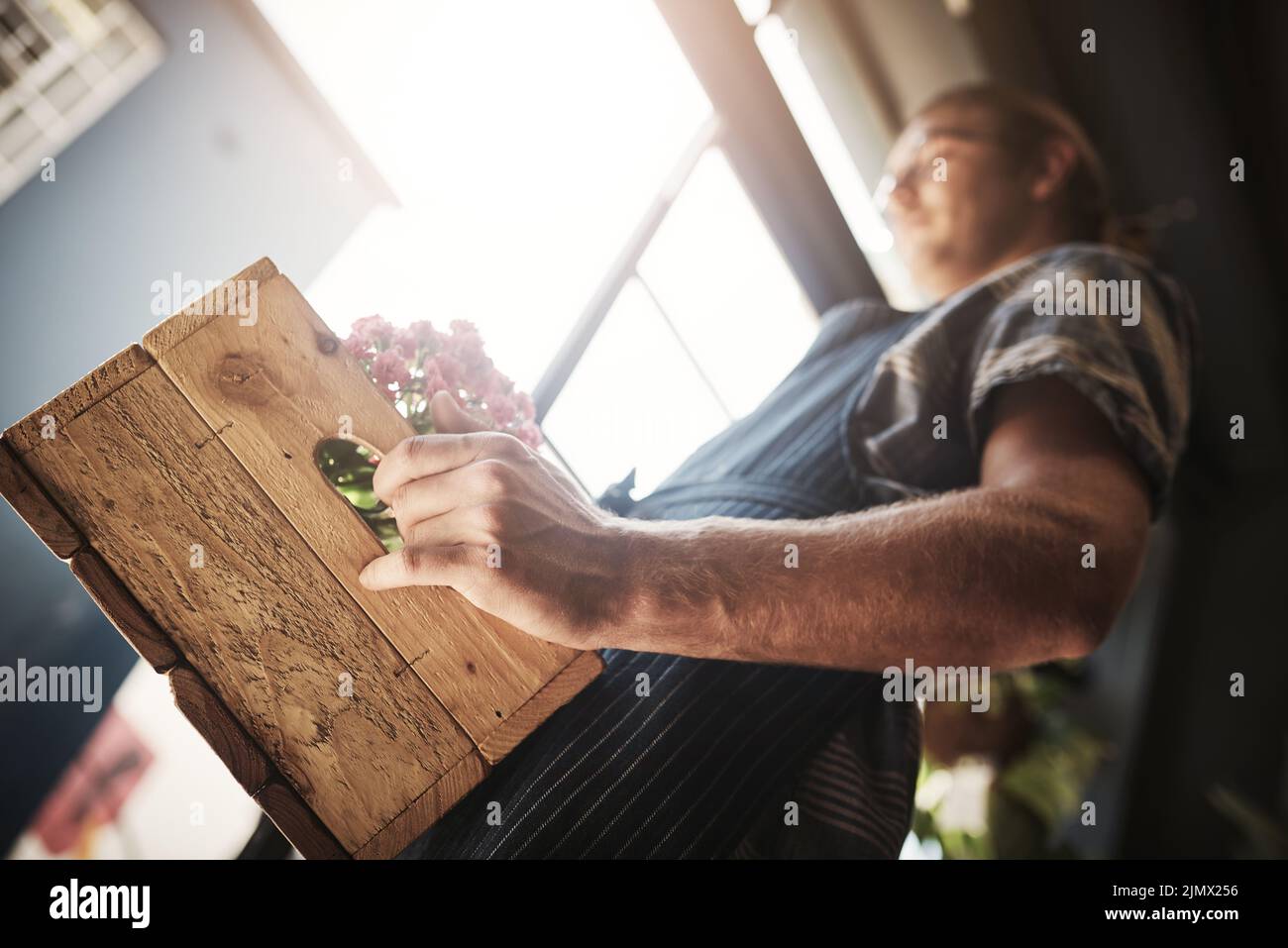 A little muscle goes a long way in this field. a florist holding a ...