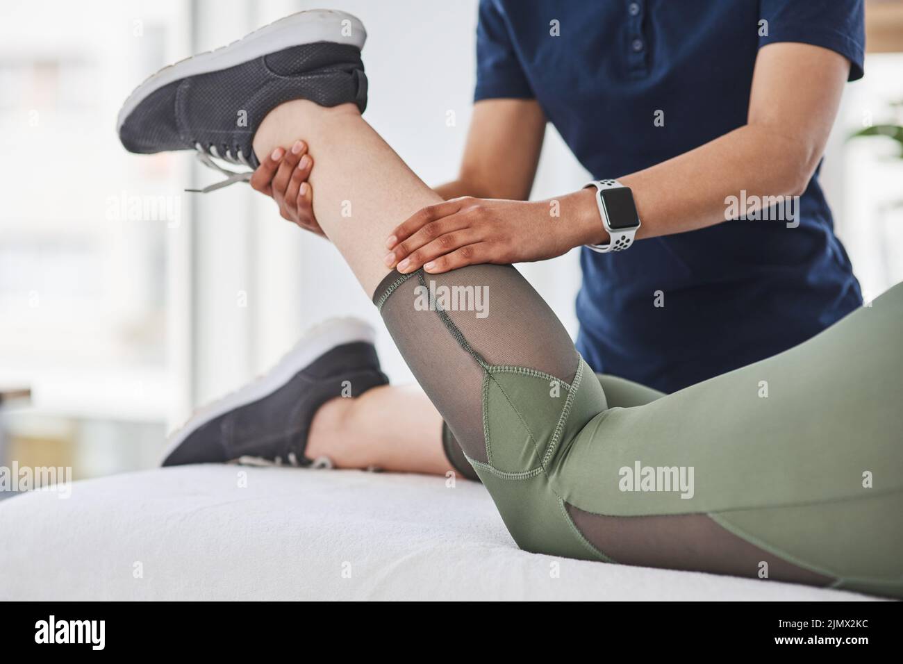 Slowly lift up your leg. an unrecognizable physiotherapist doing leg ...