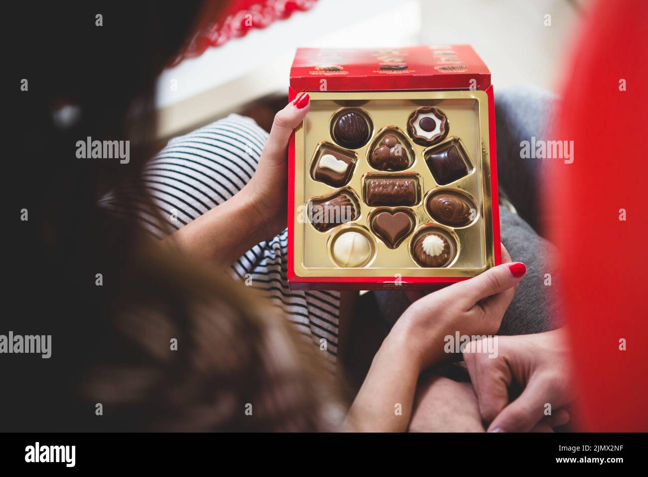Young happy woman opening present hi-res stock photography and images ...