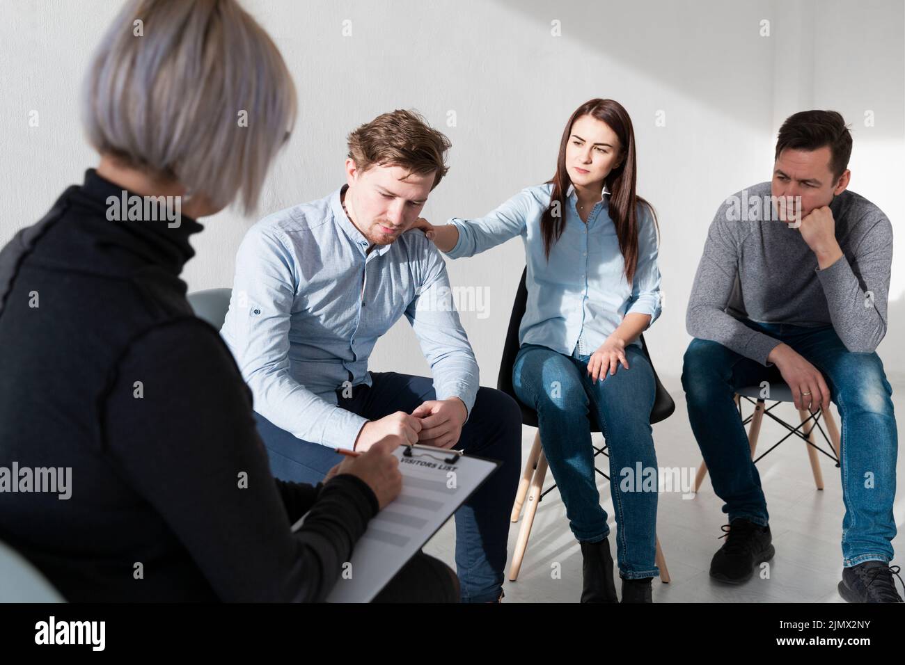 Woman holding clipboard looking sad patients Stock Photo - Alamy