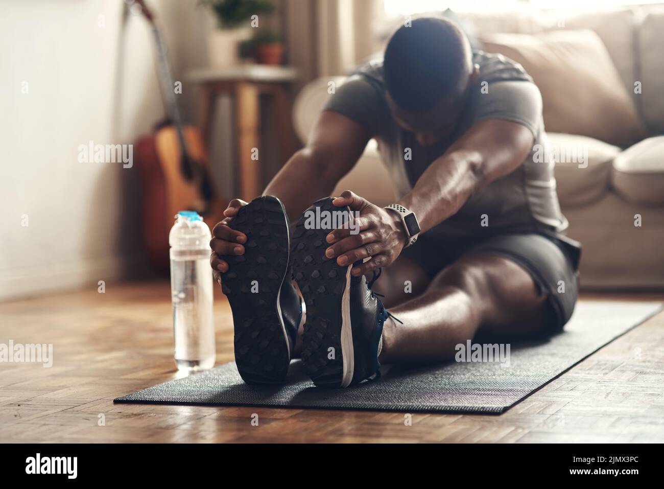 Keep pushing yourself to become the best. a sporty young man stretching ...