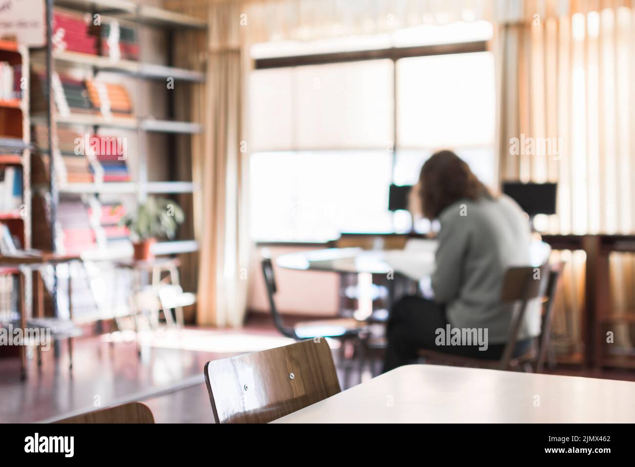 Furniture library with working person Stock Photo - Alamy