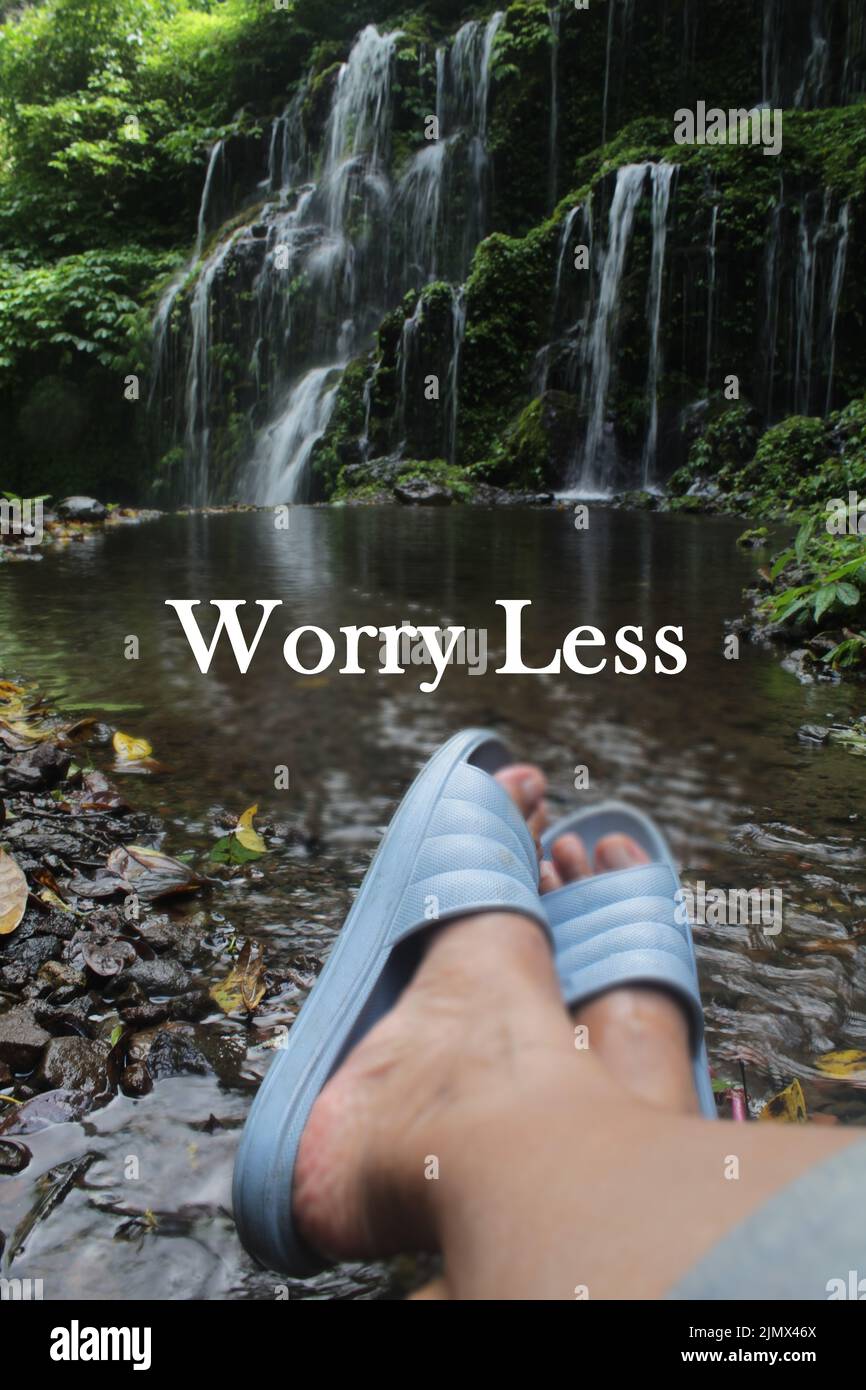 Inspirational quote - Worry less. With person sitting alone in the ...