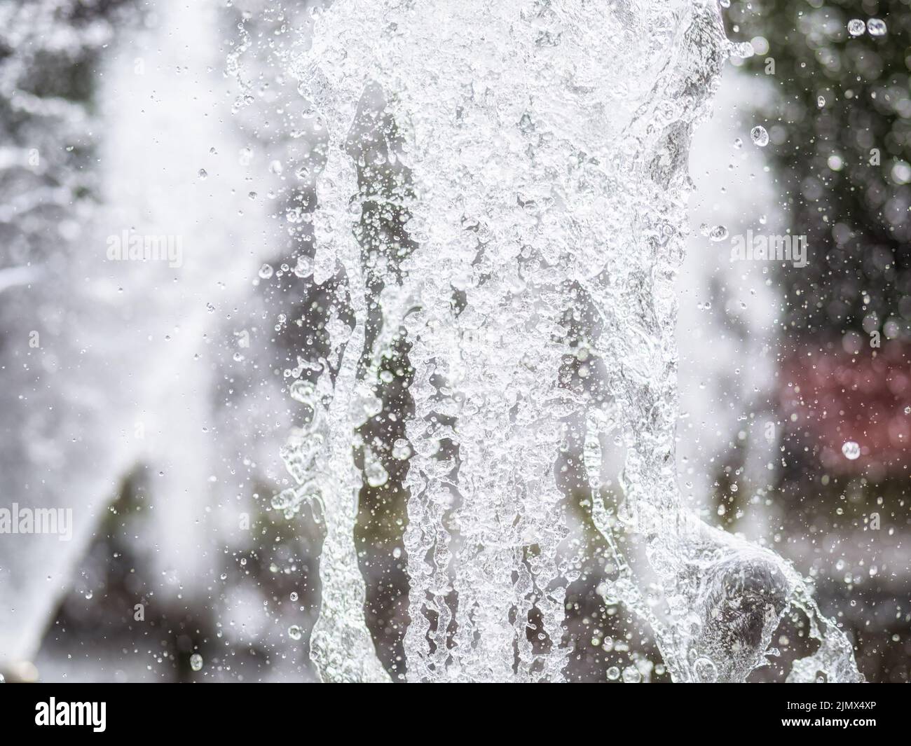 Water splashes from fountain on dark background. Natural texture of ...