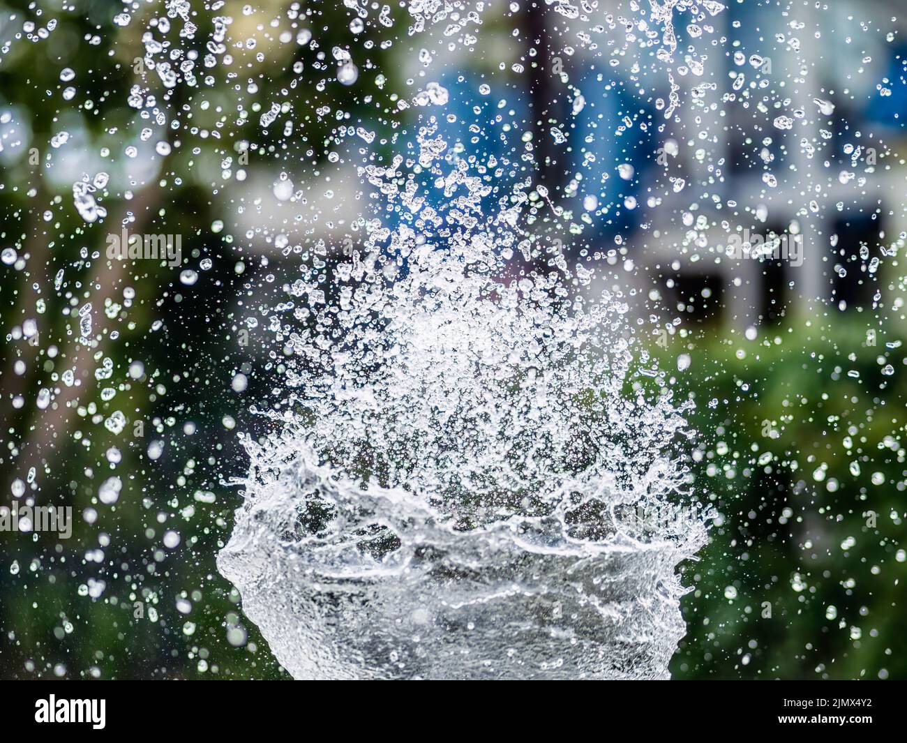 Water splashes from fountain on dark background. Natural texture of ...