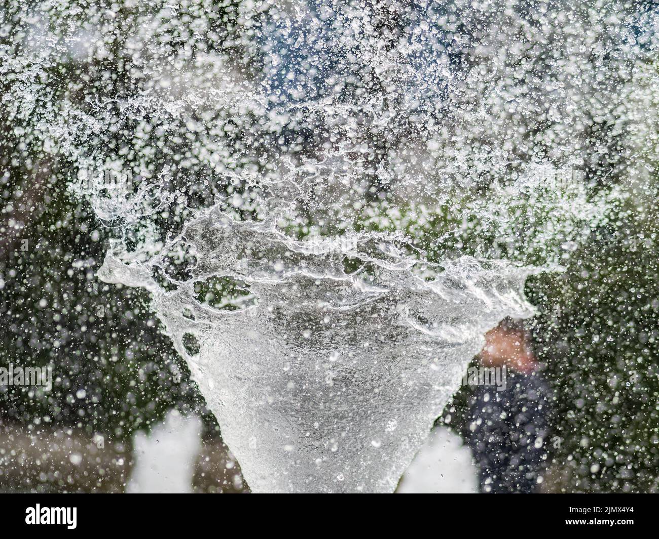 Water splashes from fountain on dark background. Natural texture of ...
