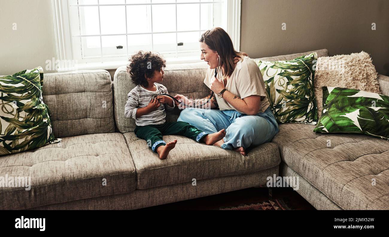 I can hear your heartbeat. a cheerful young woman and her son playing ...
