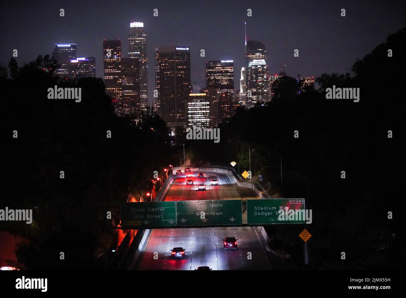 Vehicles drive on a highway at midnight in Los Angeles (LA), a modern ...