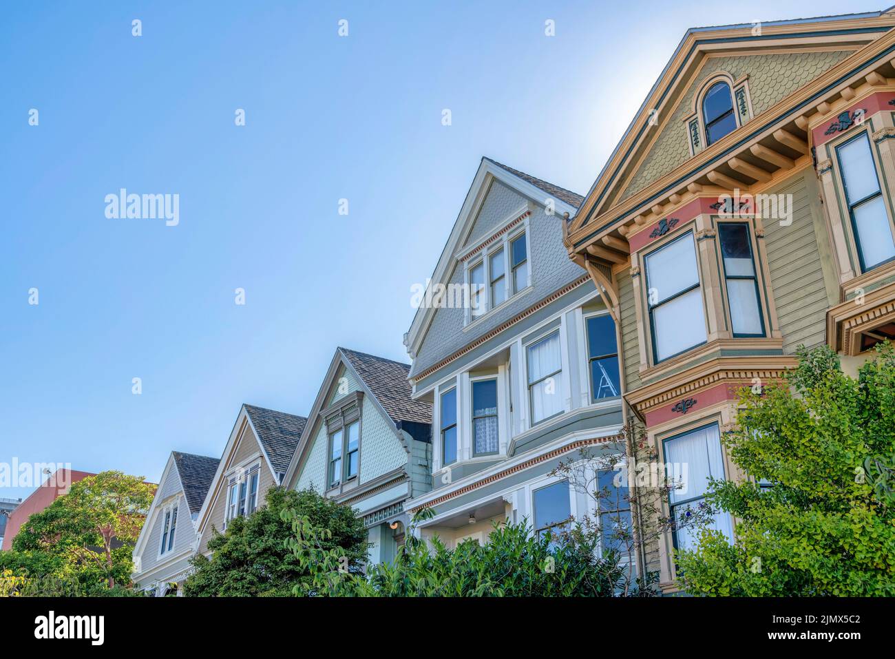 Slanted low angle view of houses with decorative shingles and bay ...
