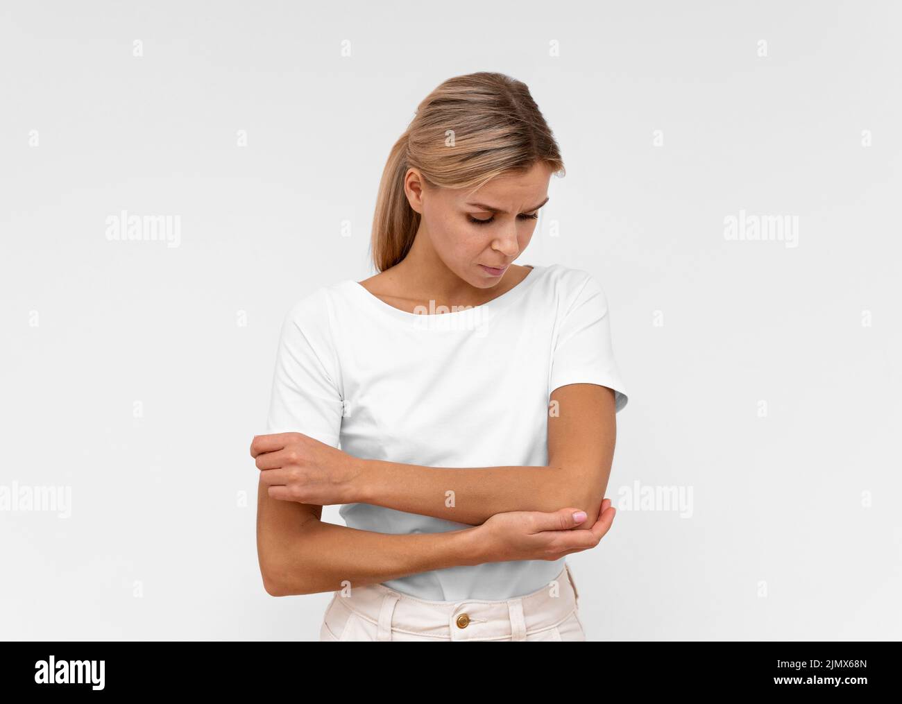 Front view woman with elbow pain Stock Photo - Alamy