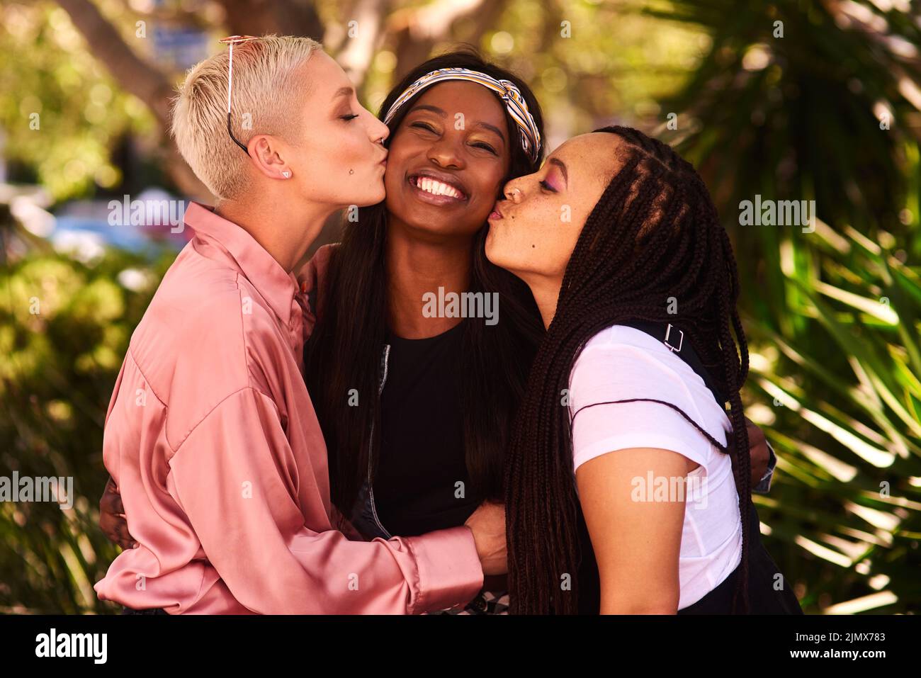We both love her to bits. two attractive young women kissing their ...