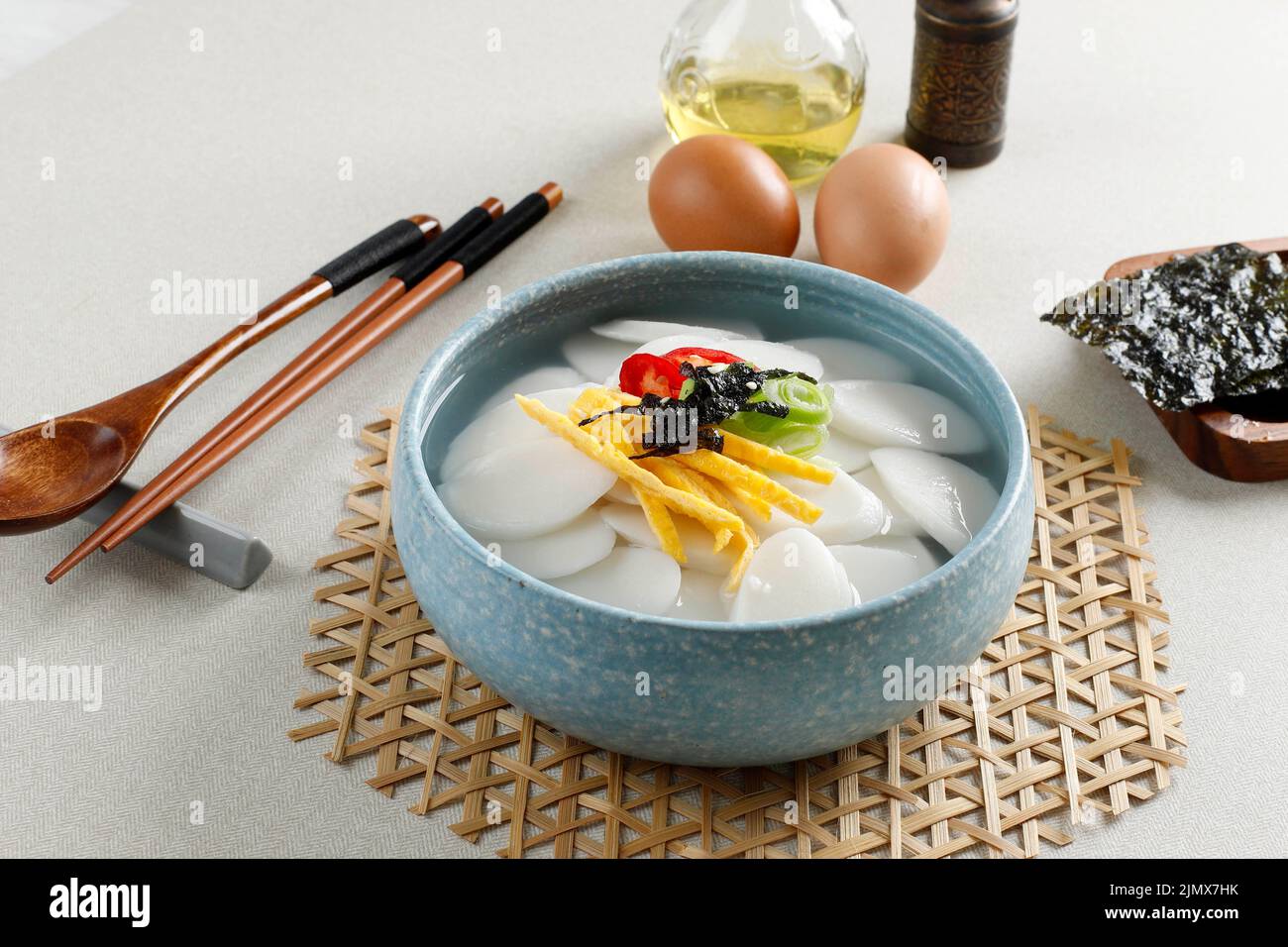 Korean Slice Cake Soup or Tteokguk on Blue Bowl. Topping with Egg ...