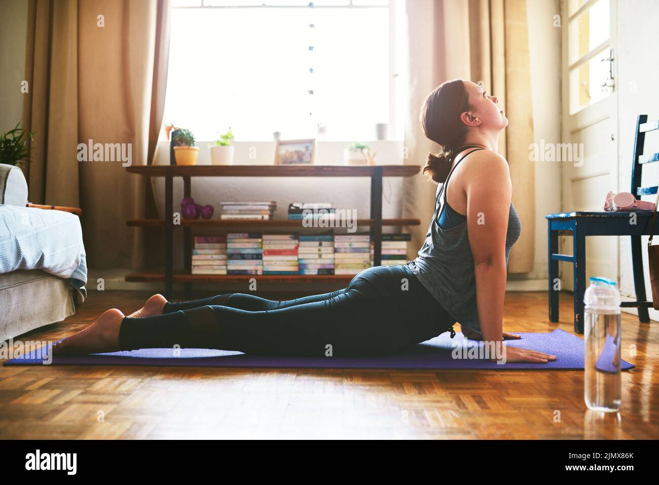 Opening the chest. an attractive young woman sitting and holding a ...