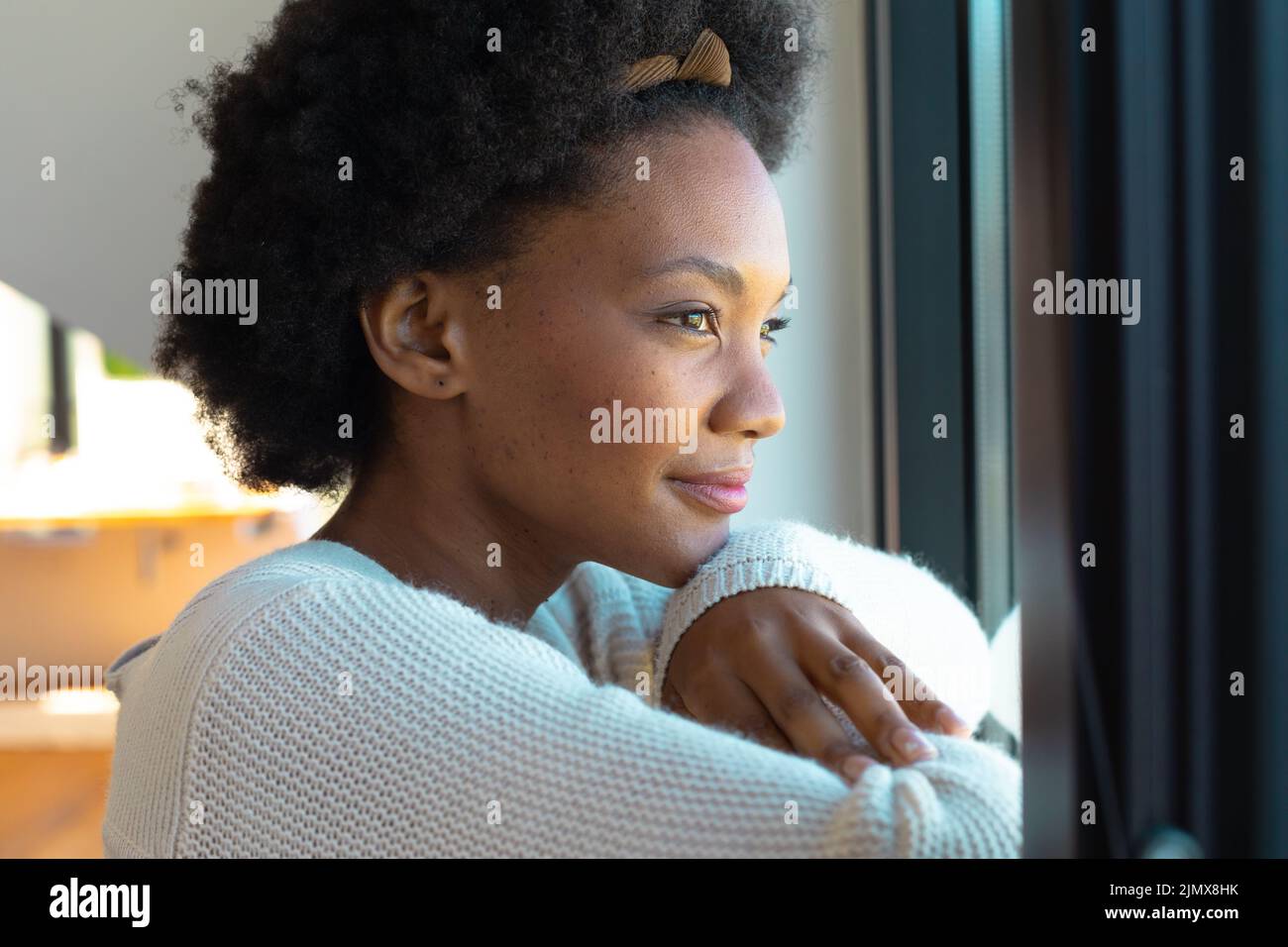 Side view of thoughtful young african american afro woman looking ...